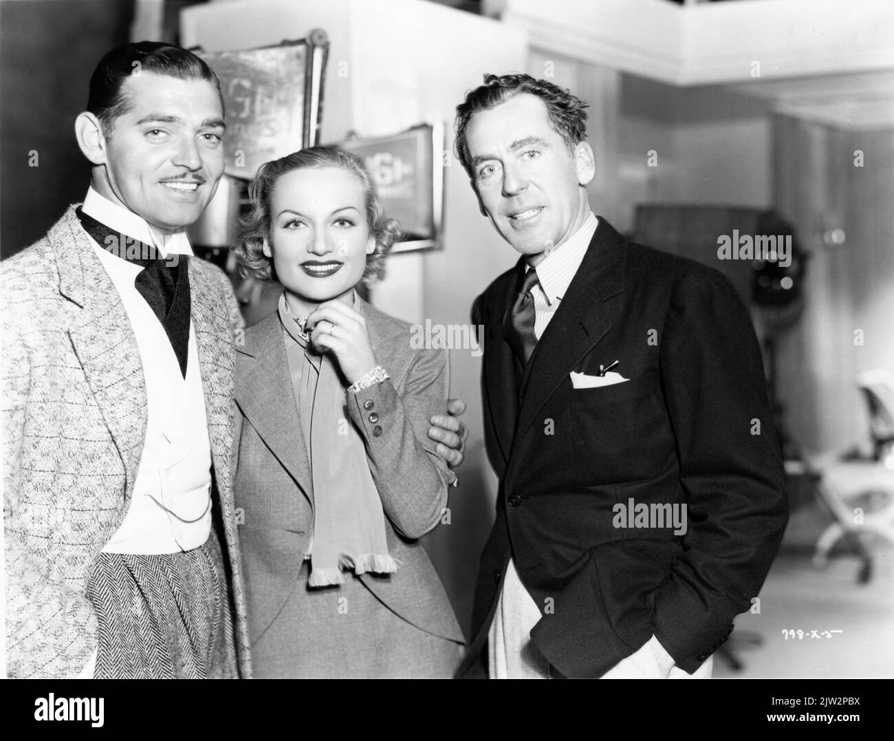 Set Visitor CLARK GABLE with CAROLE LOMBARD and Director JACK CONWAY on set candid during ...
