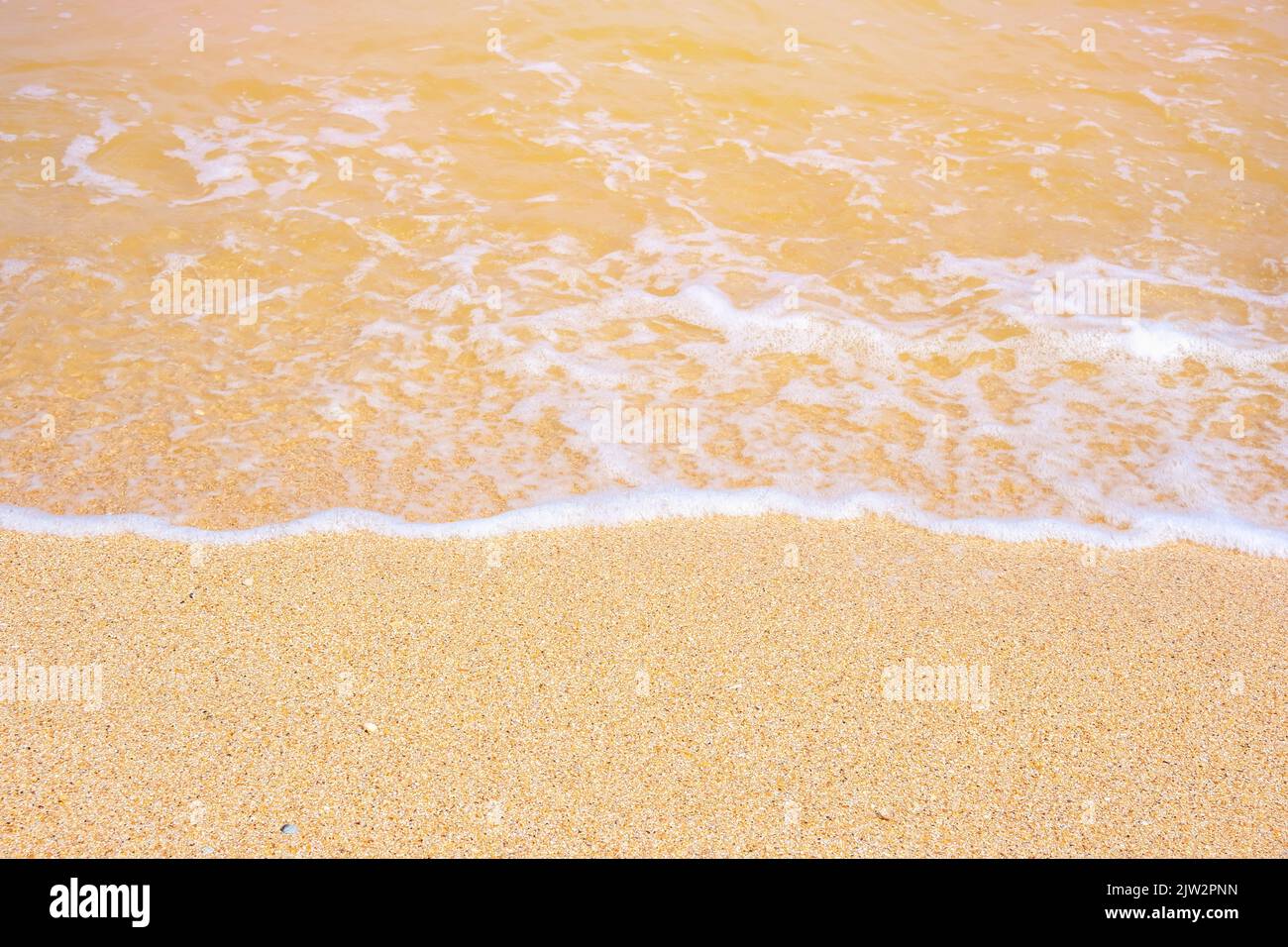 The coast of the Sea of Azov. Sea waves roll on the sandy shore ...