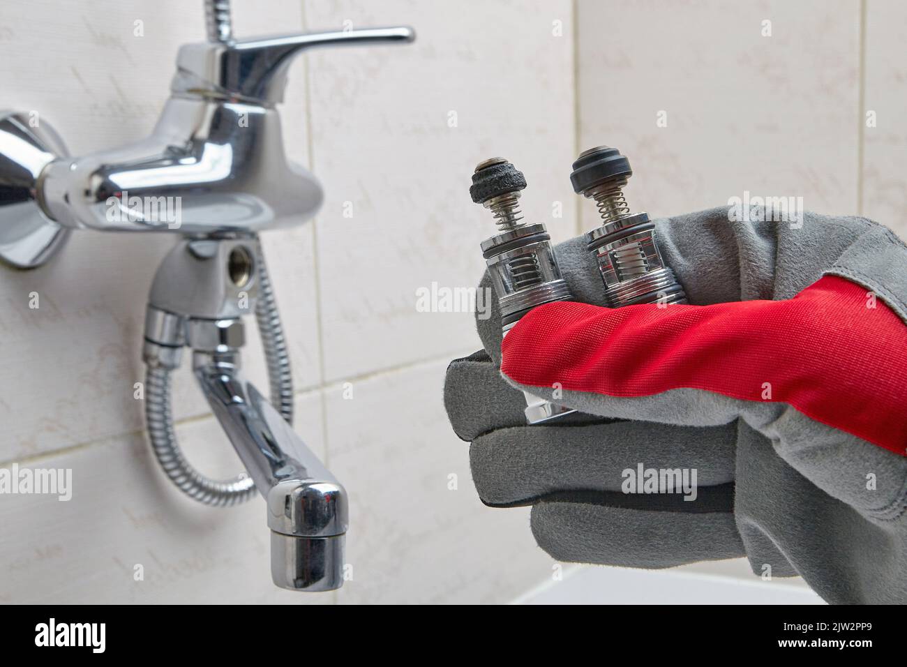 Plumber showing a worn and new shower valve switch. Plumbing shower ...