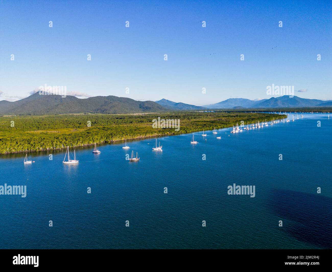 Aerial photo of perfect blue water and sky with mountains and boats ...