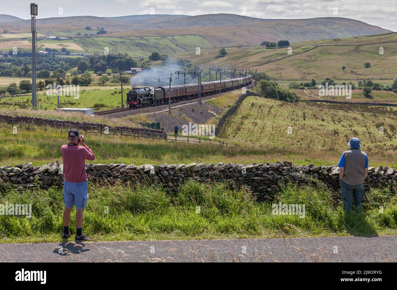 Rail enthusiasts ( Train spotters )photographing Steam locomotive 46115 ...