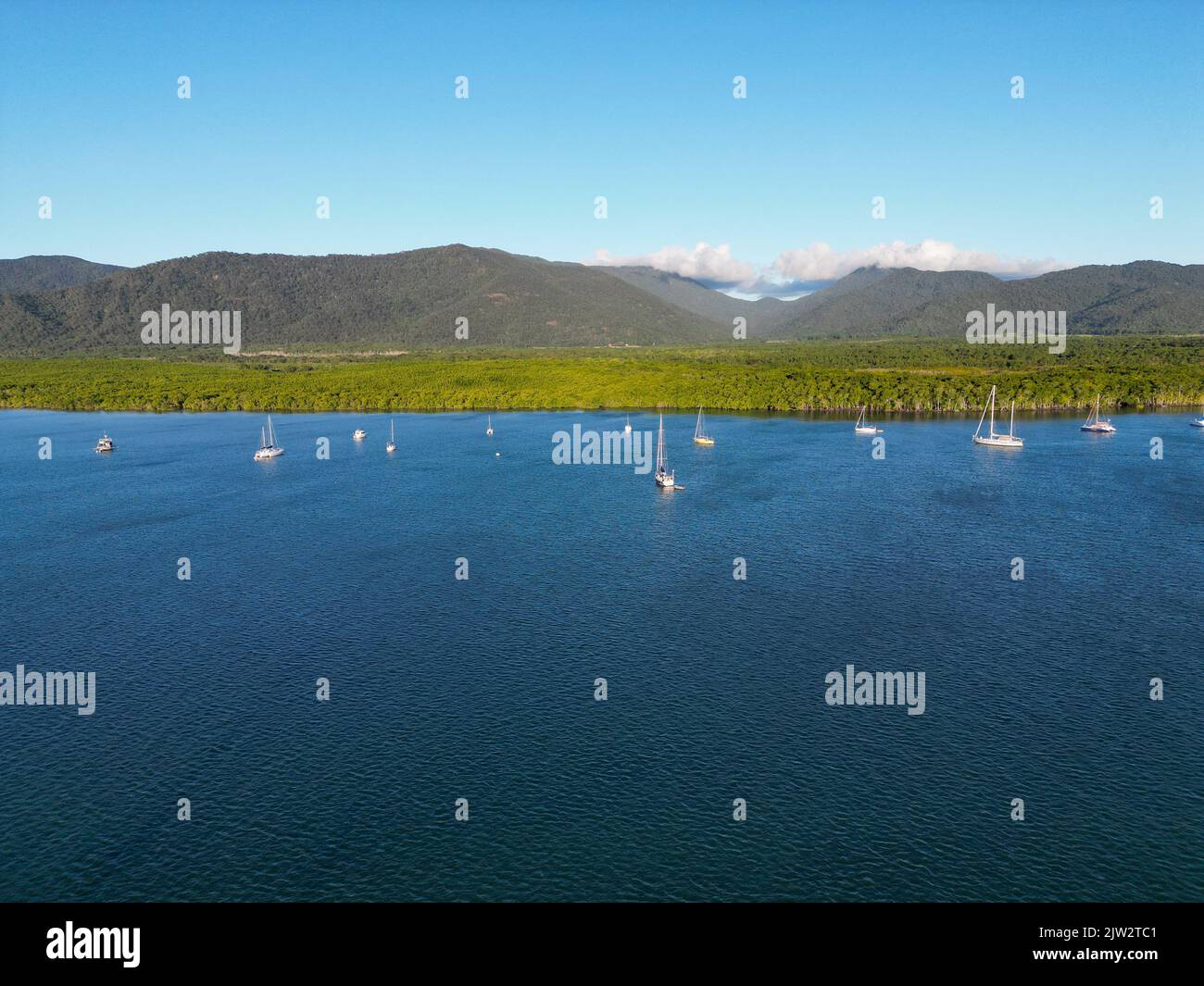 Aerial photo of perfect blue water and sky with mountains and boats ...