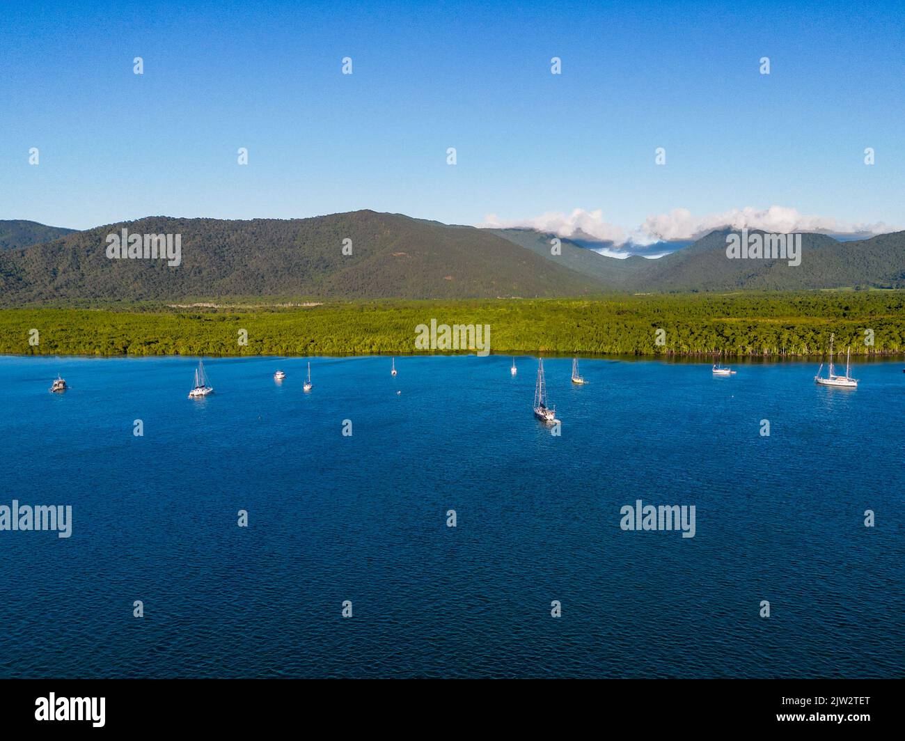 Aerial photo of perfect blue water and sky with mountains and boats ...