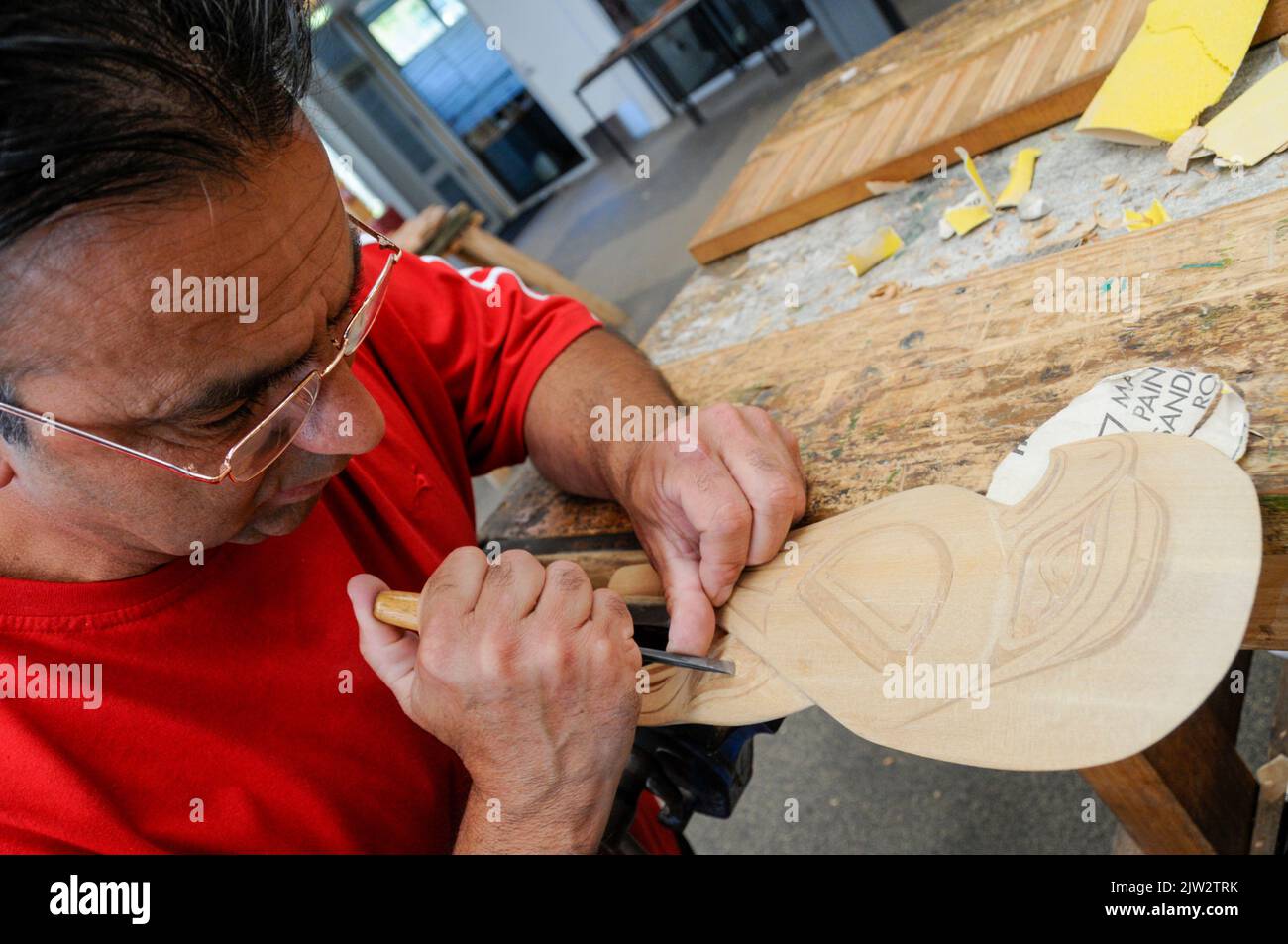 A wood carver is working on a Maori carving at the Carving school at Te ...