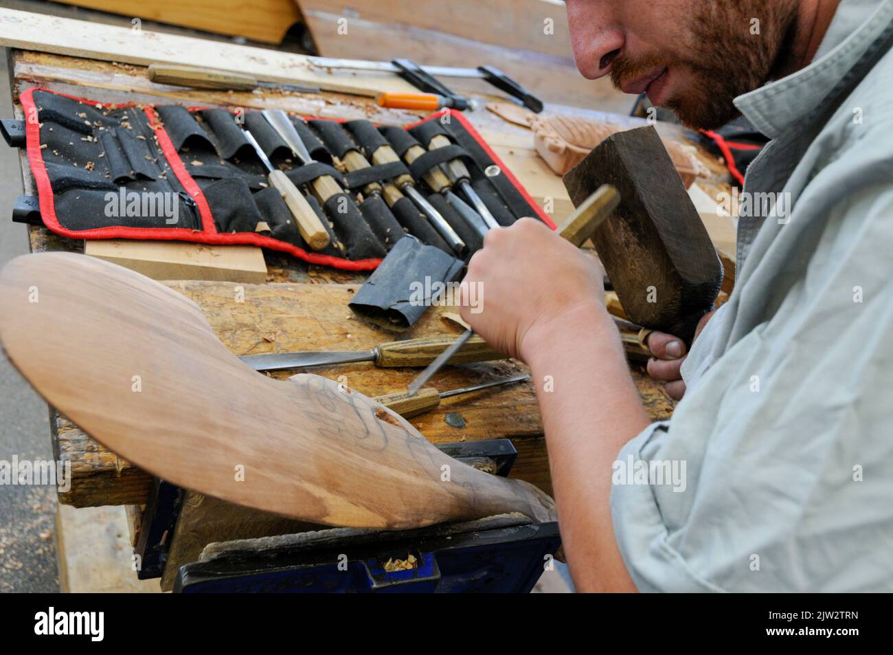 A wood carver is working on a Maori carving at the Carving school at Te ...