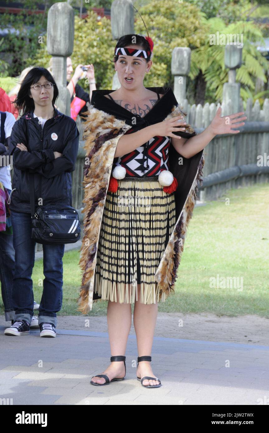 A Maori woman give an introduction talk about Maori culture to a group ...
