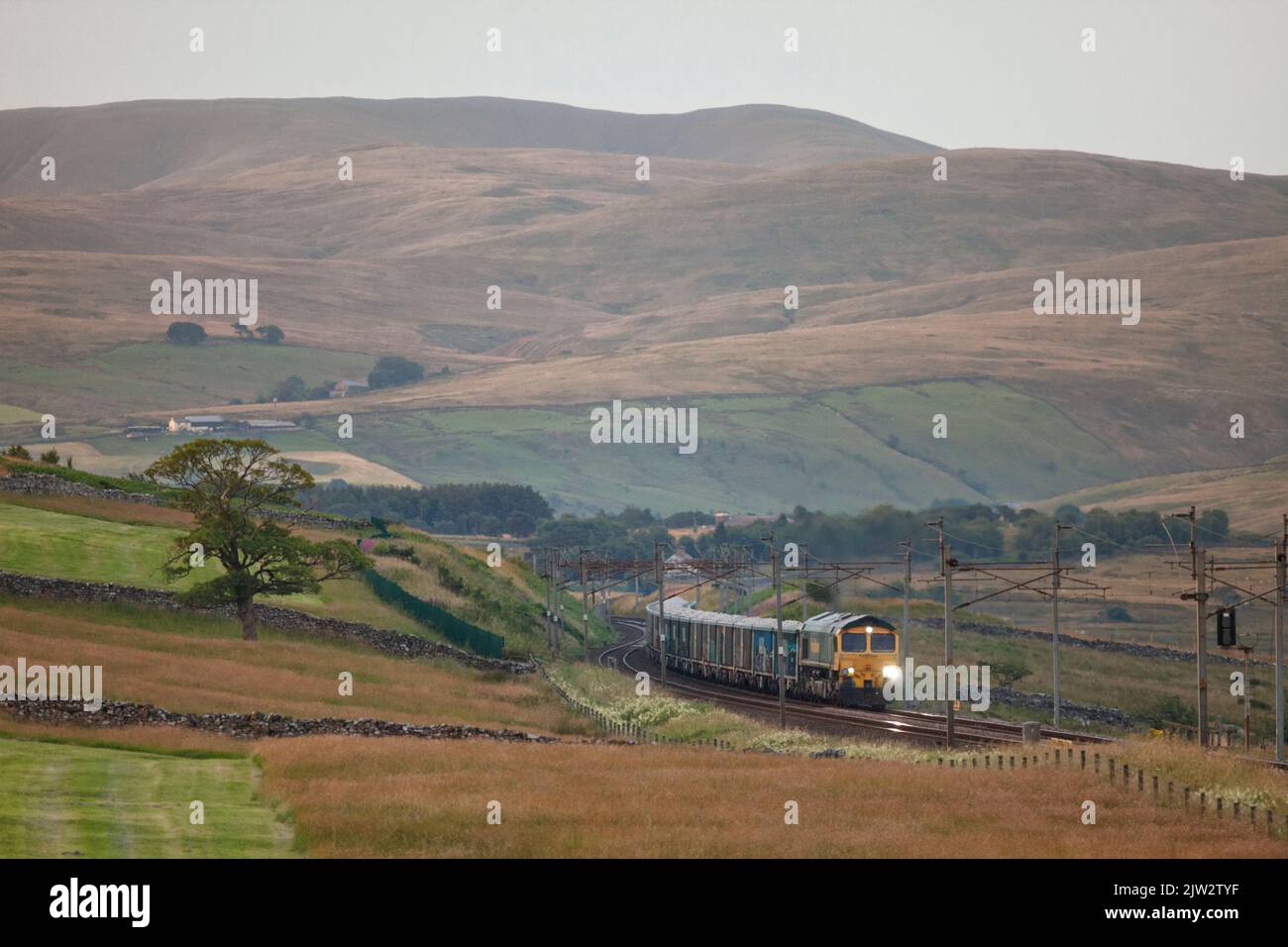 A Freightliner Class 66 locomotive climbing Shap bank, on the west ...