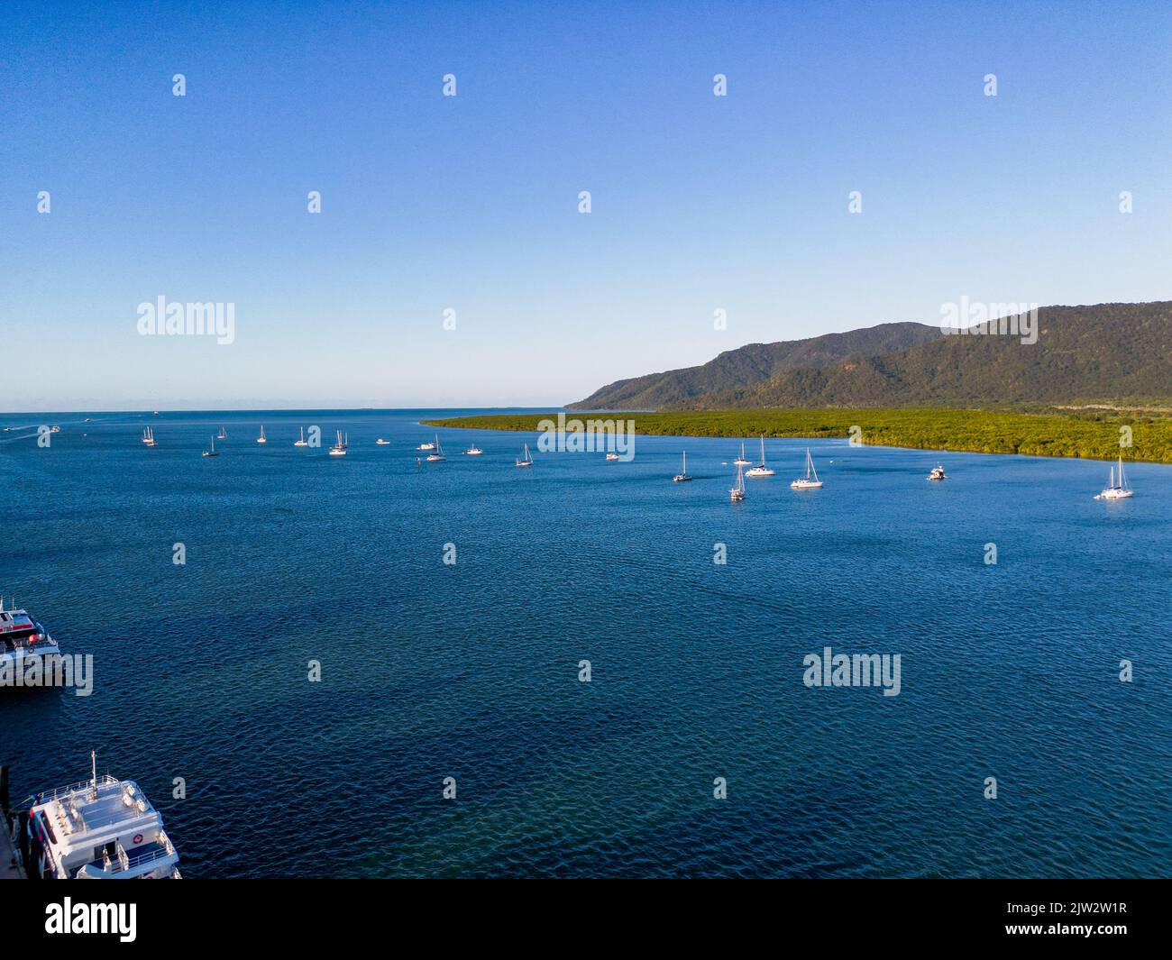 Aerial photo of perfect blue water and sky with mountains and boats ...