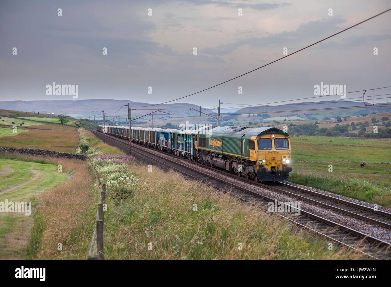 A Freightliner Class 66 locomotive climbing Shap bank, on the west ...