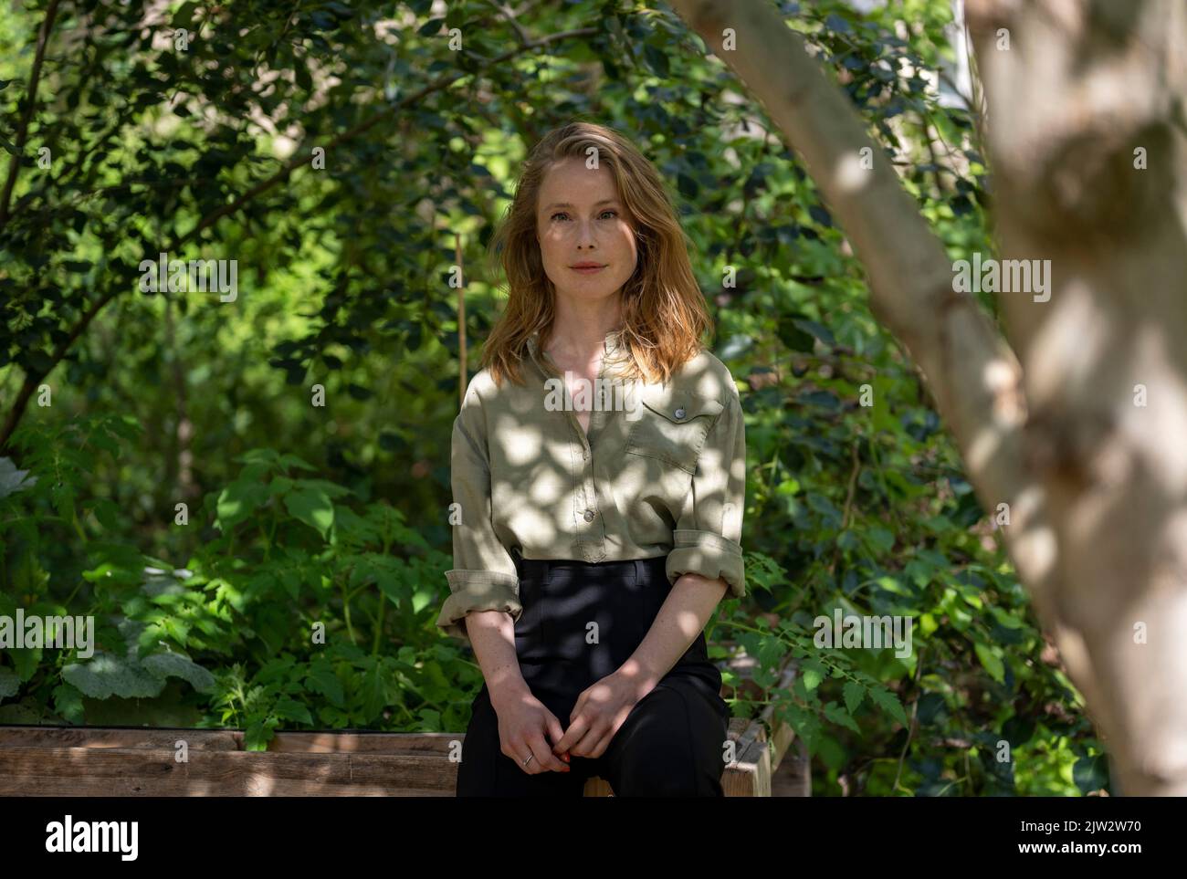 Berlin, Germany. 02nd Sep, 2022. Actress Odine Johne stands in a garden ...