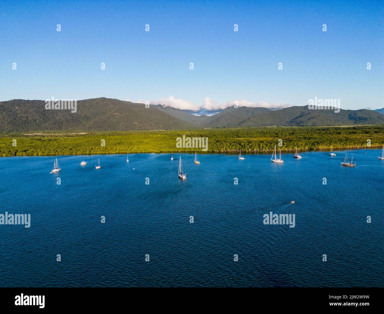 Aerial photo of perfect blue water and sky with mountains and boats ...