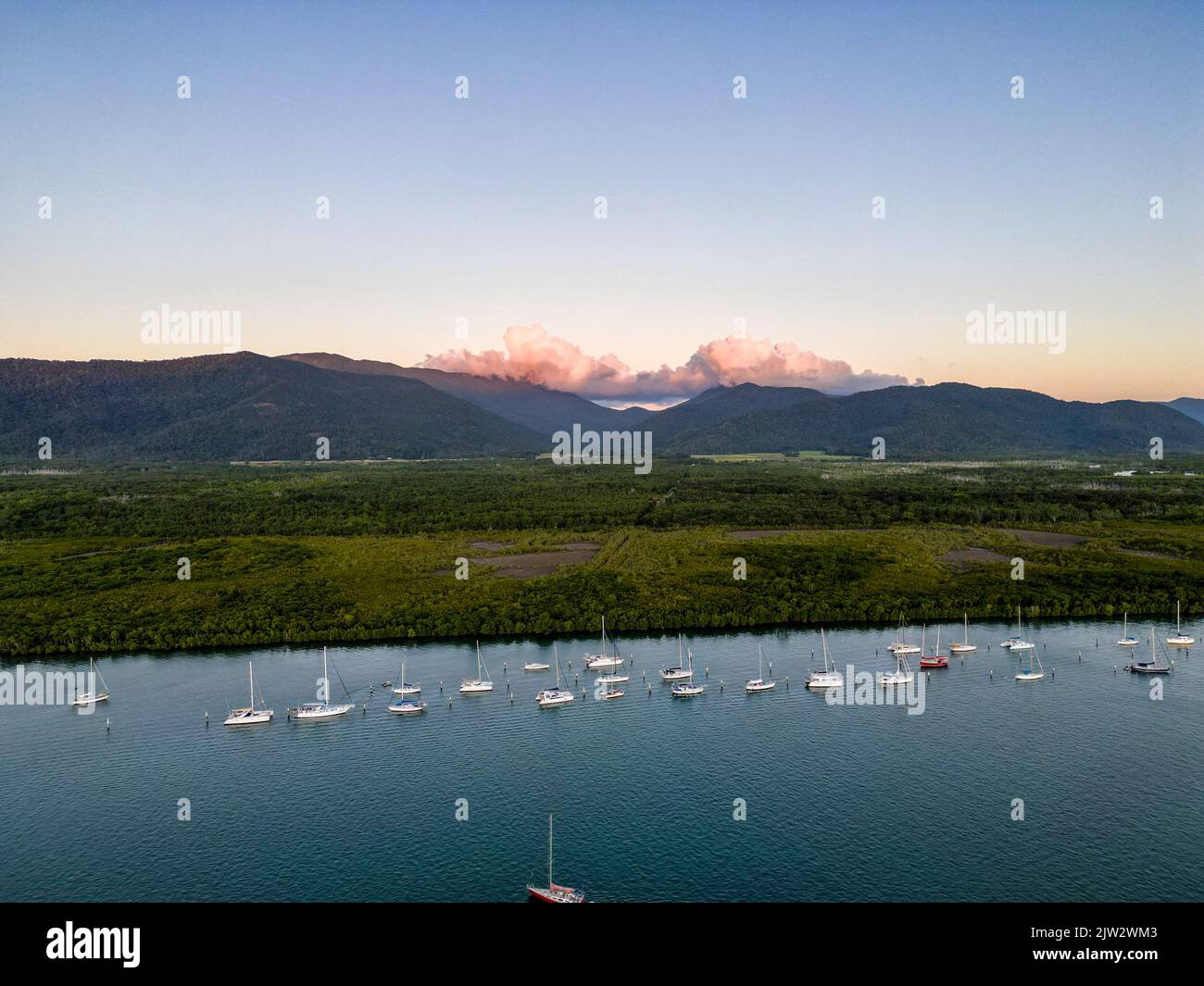 Aerial photo of perfect blue water, sunset sky and boats docked Stock ...