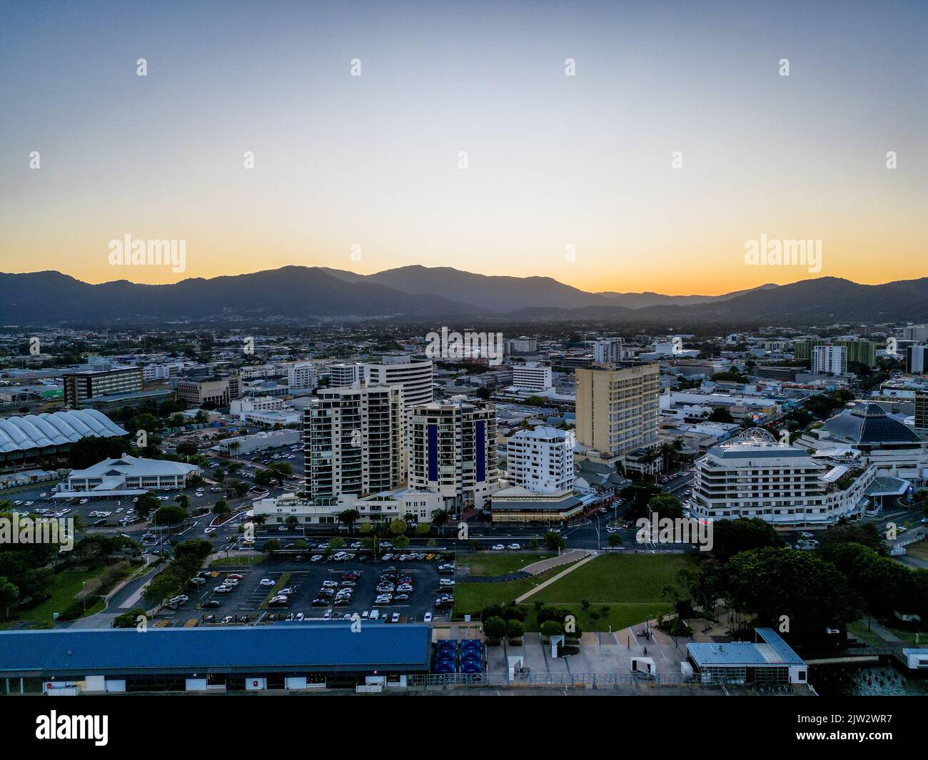 Aerial sunset photo of Cairns cityscape with a mountain backdrop and ...