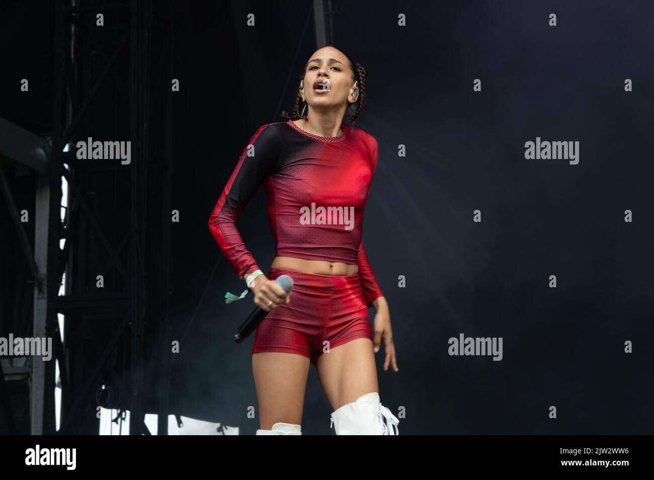 Maeve singing wearing a red top and shorts Stock Photo - Alamy