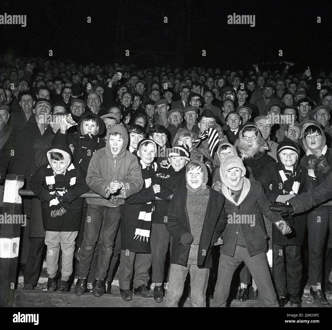 1960s, historical, football fans, evening match, excited young fans ...