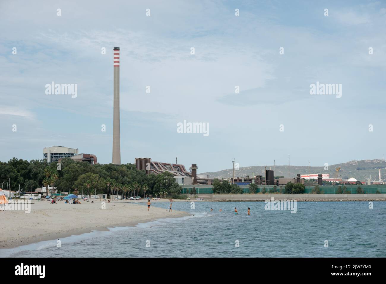 People bathing in a beautiful white sand beach located next to a ...