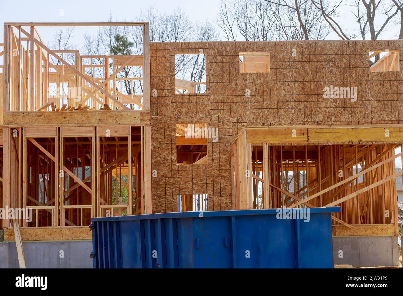 A rubbish removal container on of a house underneath an industrial ...