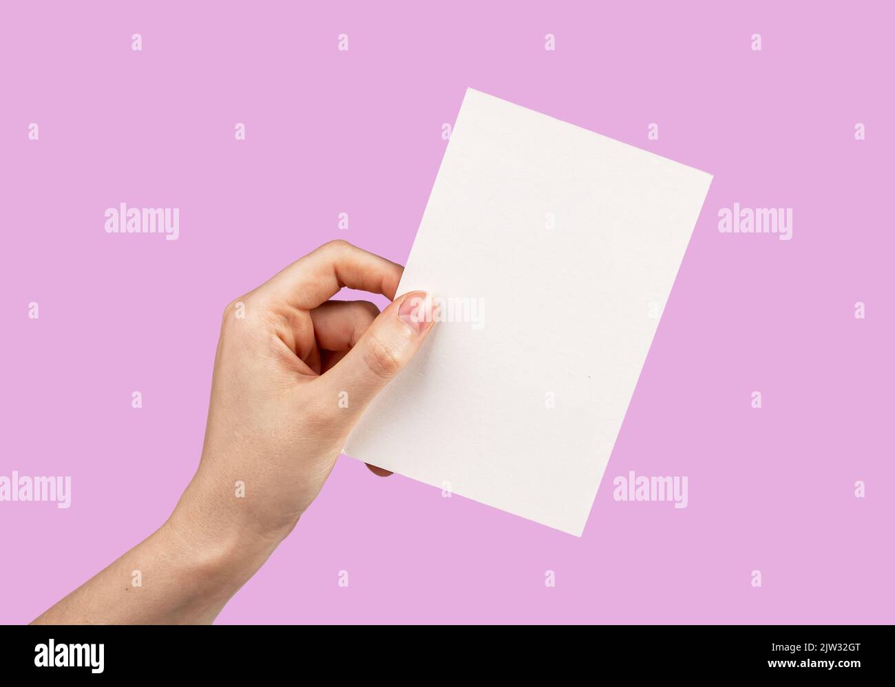 Hand holding card mockup on pink background. Template for ...