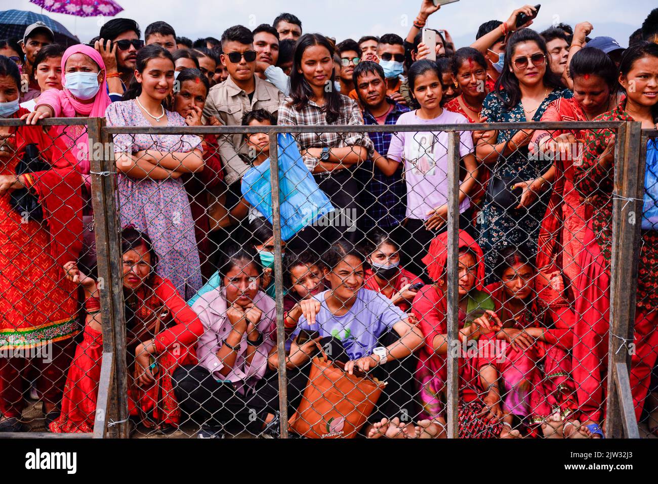 People watch as Nepali devotees donned in traditional attires dance ...