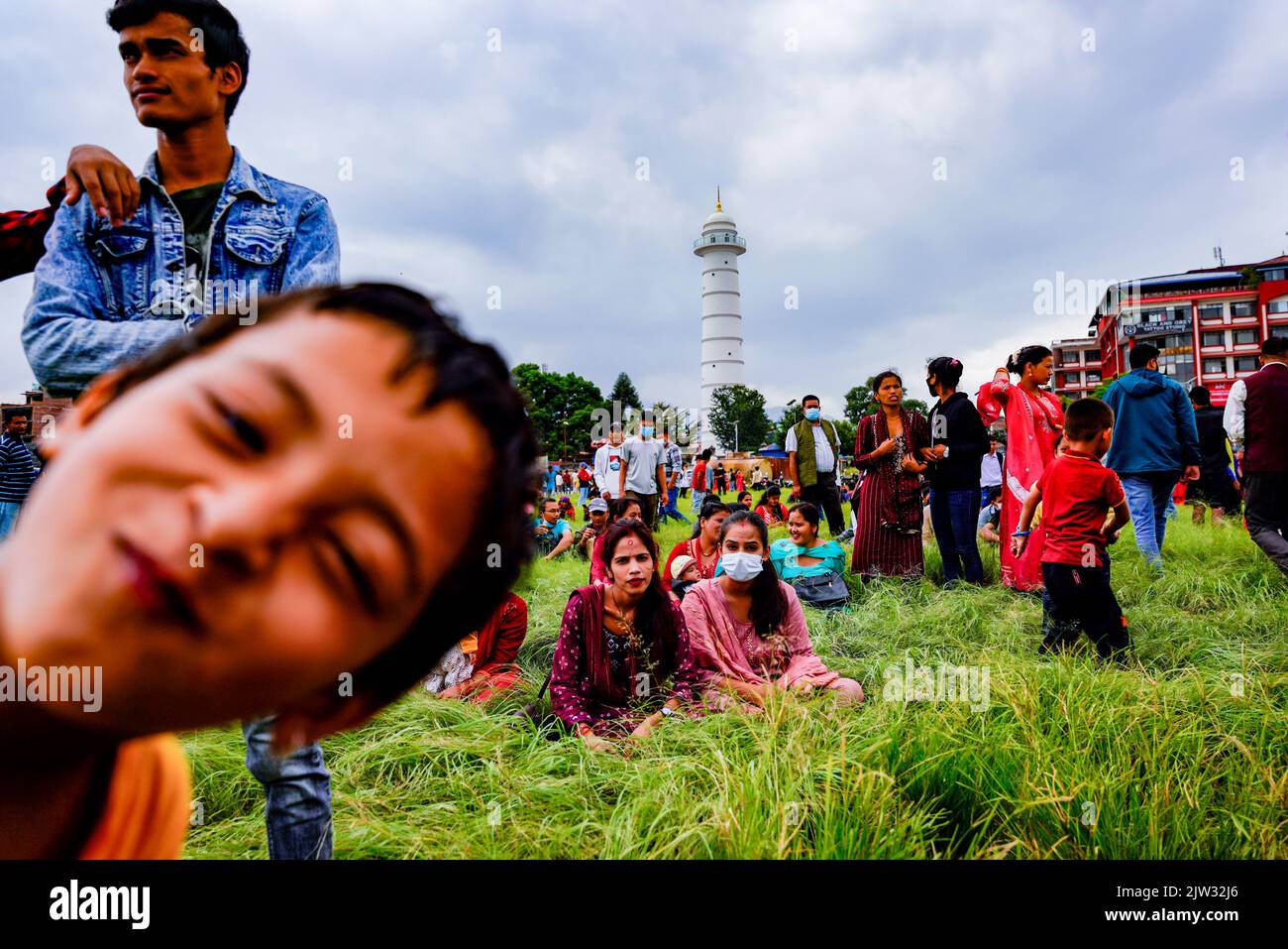 People watch as Nepali devotees donned in traditional attires dance ...