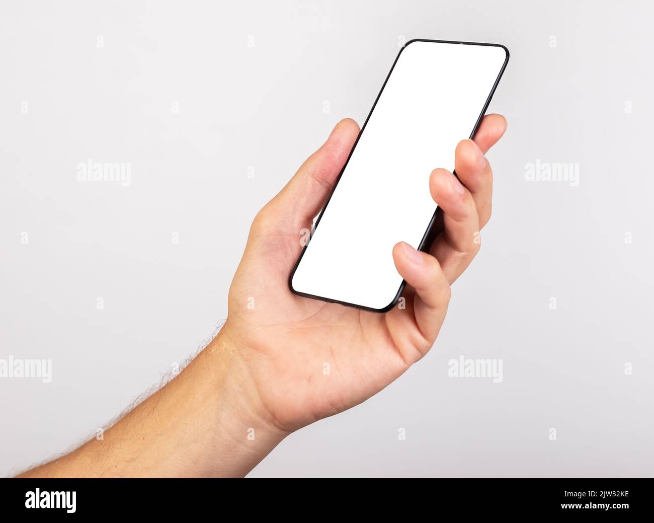 Hand holding phone mockup in angled position. template with empty ...