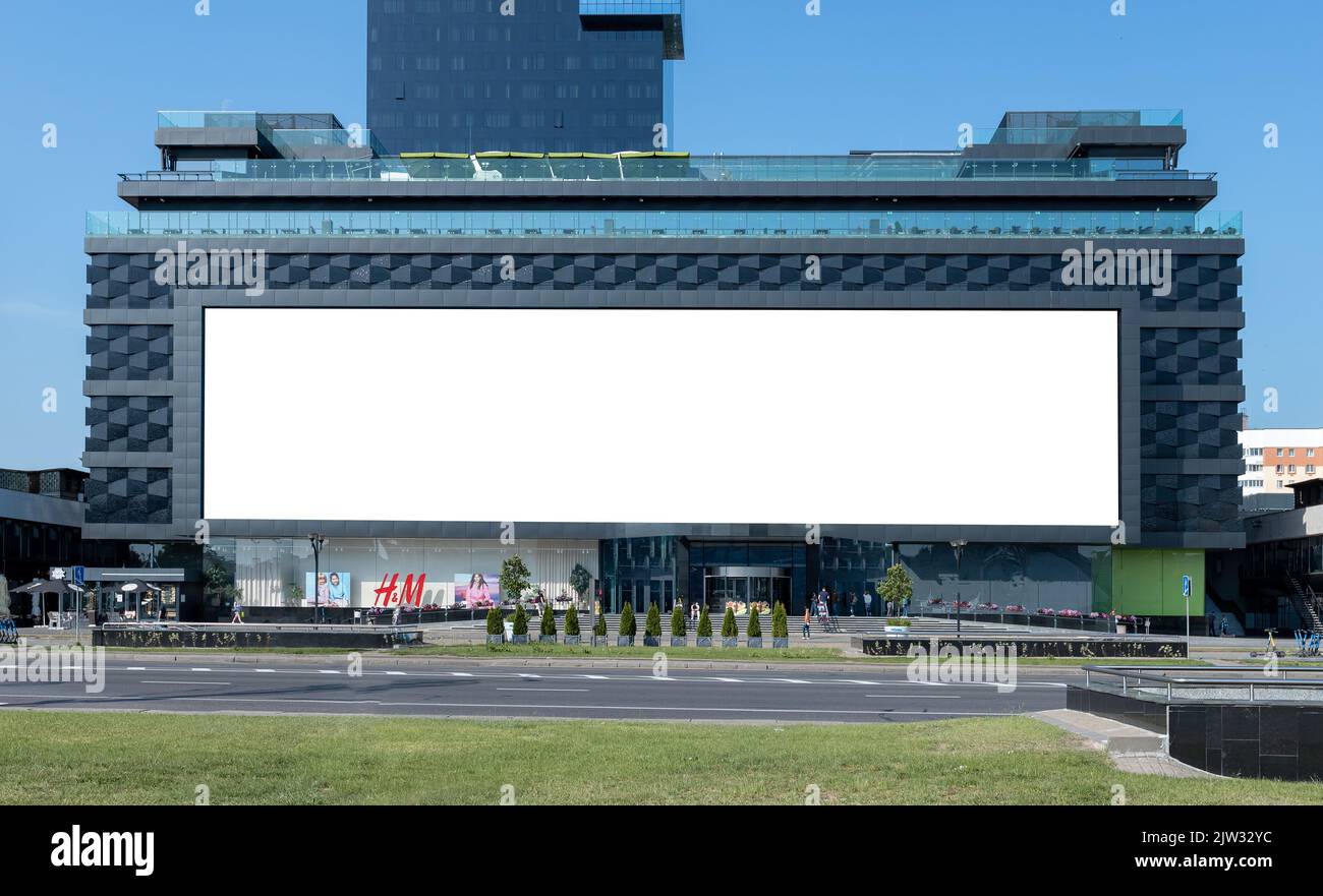 Huge billboard at mall facade in city high traffic area. Business ...