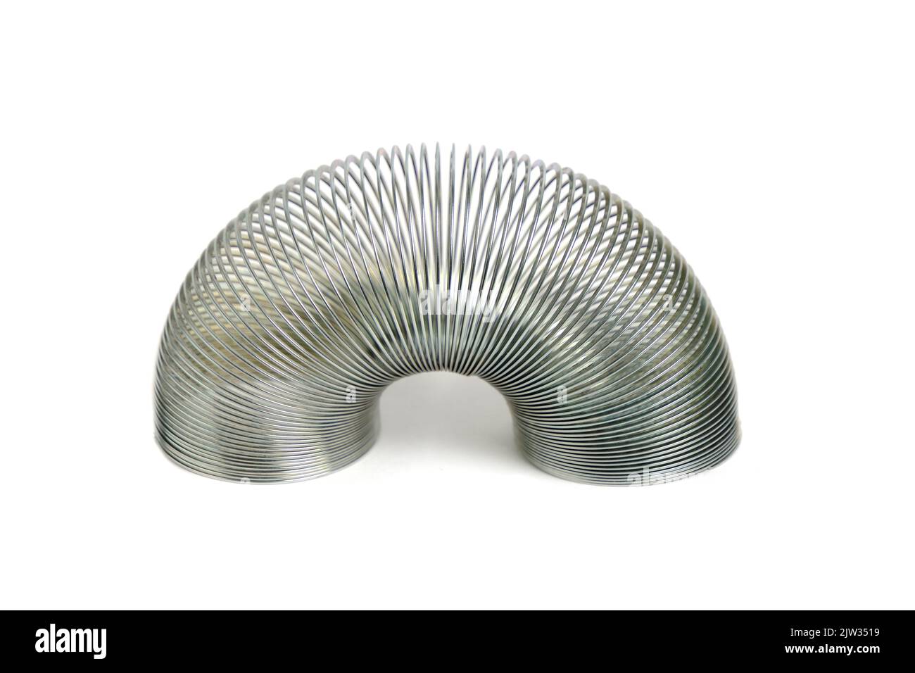 Metal toy antistress spring slinky, on white background Stock Photo - Alamy