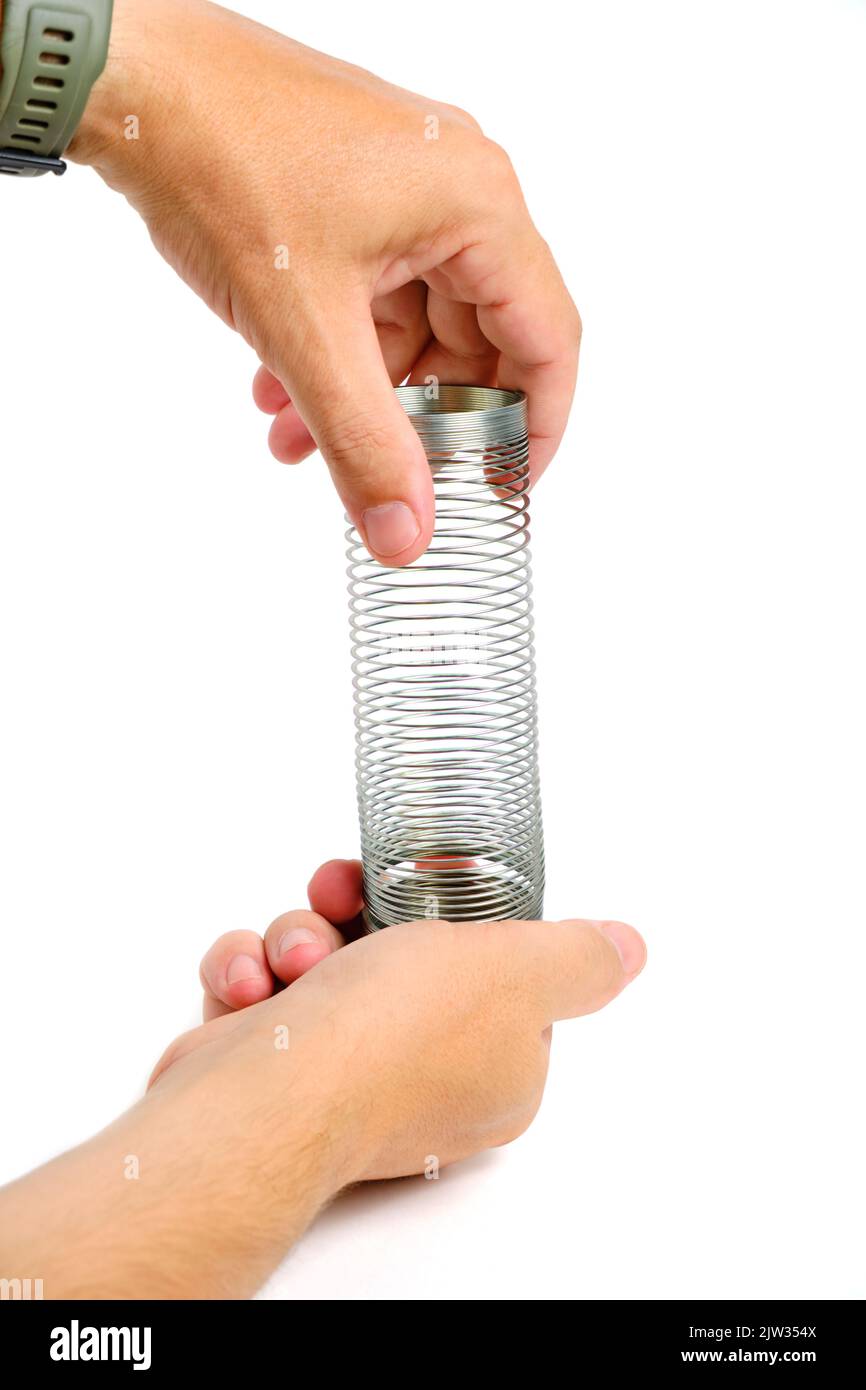 Metal spring antistress toy,slinky, in hand white background Stock ...