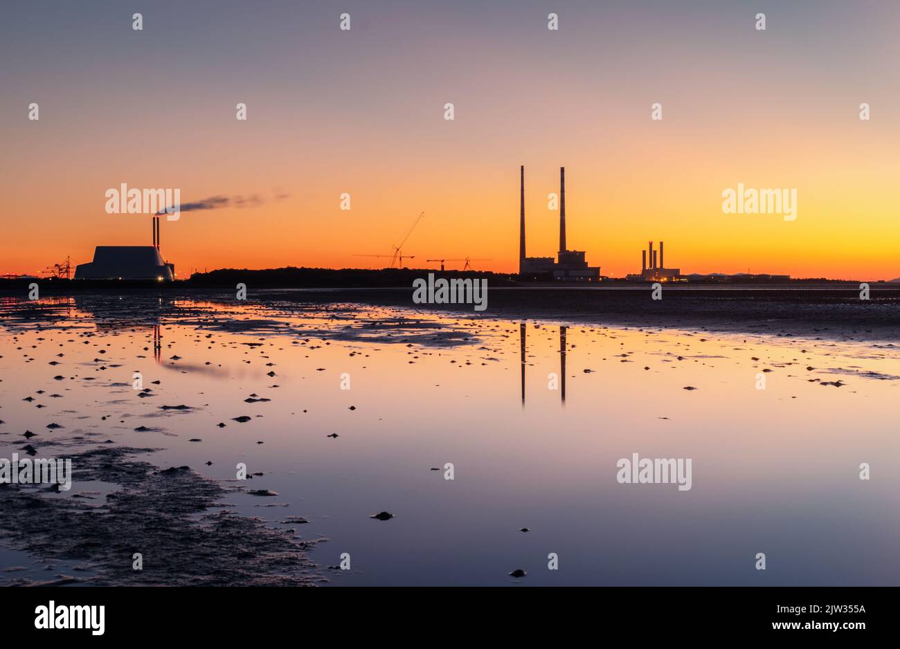Sandymount Strand low tide reflections of Poolbeg at dawn Stock Photo ...