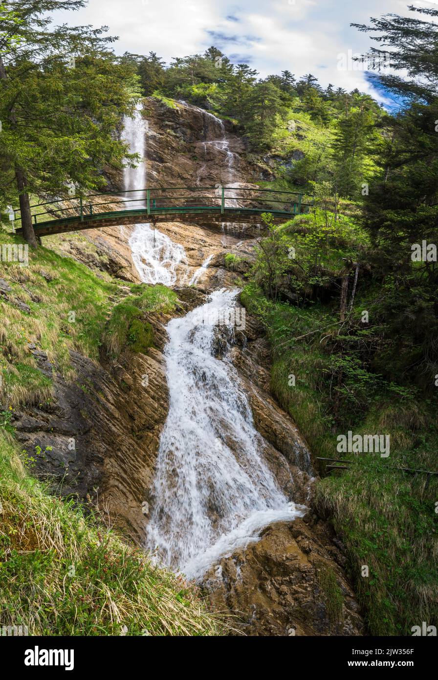 An amazing view of a Zipfelsbach waterfall and the green wooden bridge ...