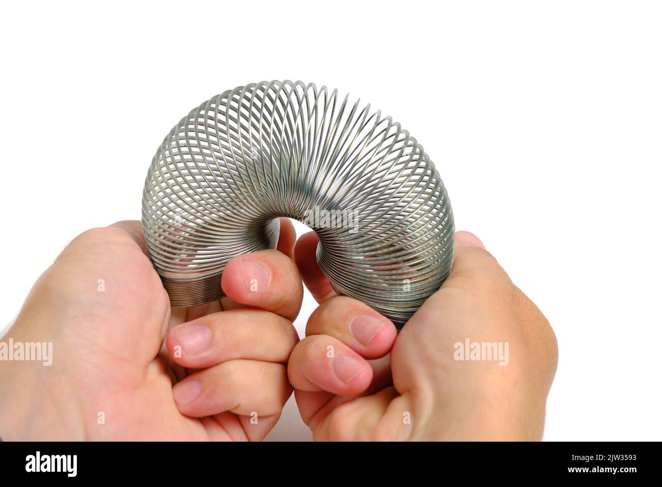 Metal spring antistress toy,slinky, in hand white background Stock ...