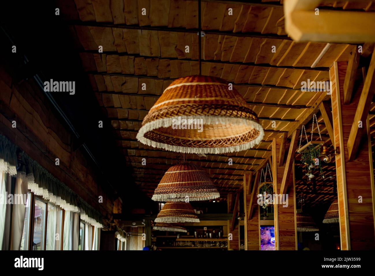 Wicker straw lamps, wooden roof. Trendy interior design of a hipster ...