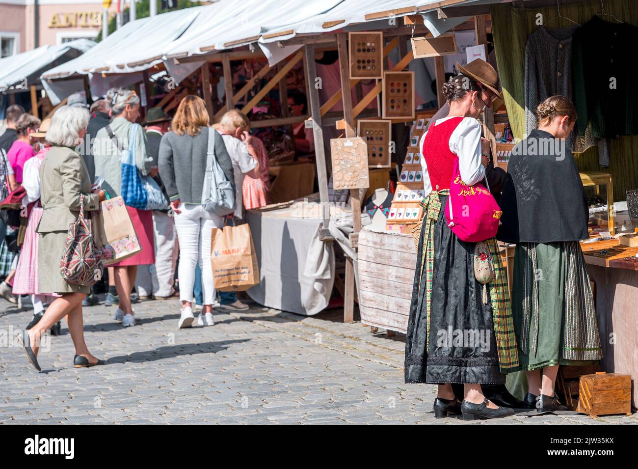 Greding, Germany. 03rd Sep, 2022. Visitors look around the stalls on ...