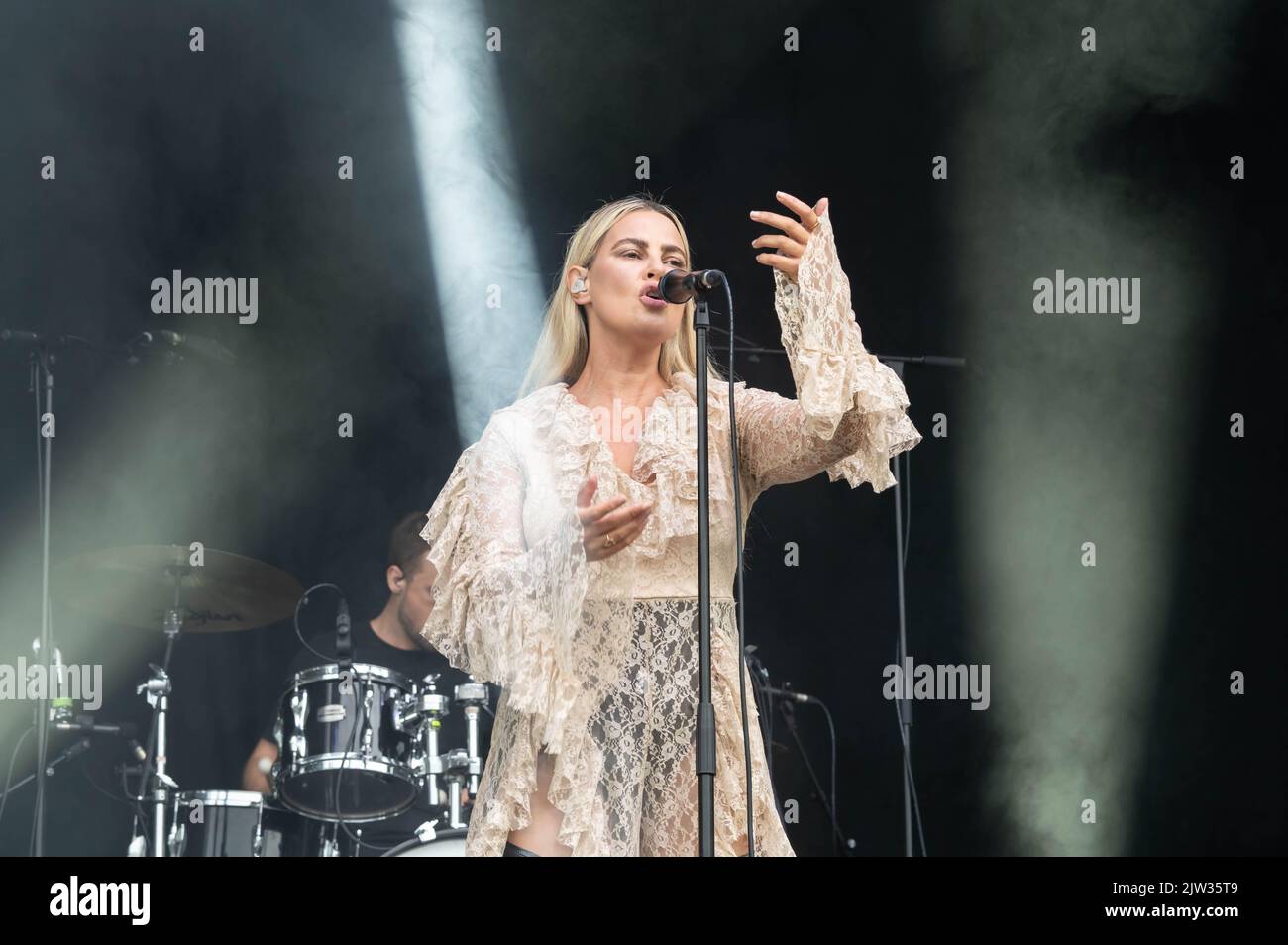 Lyra - singing to the connect audience wearing a lace thrilled blouse ...