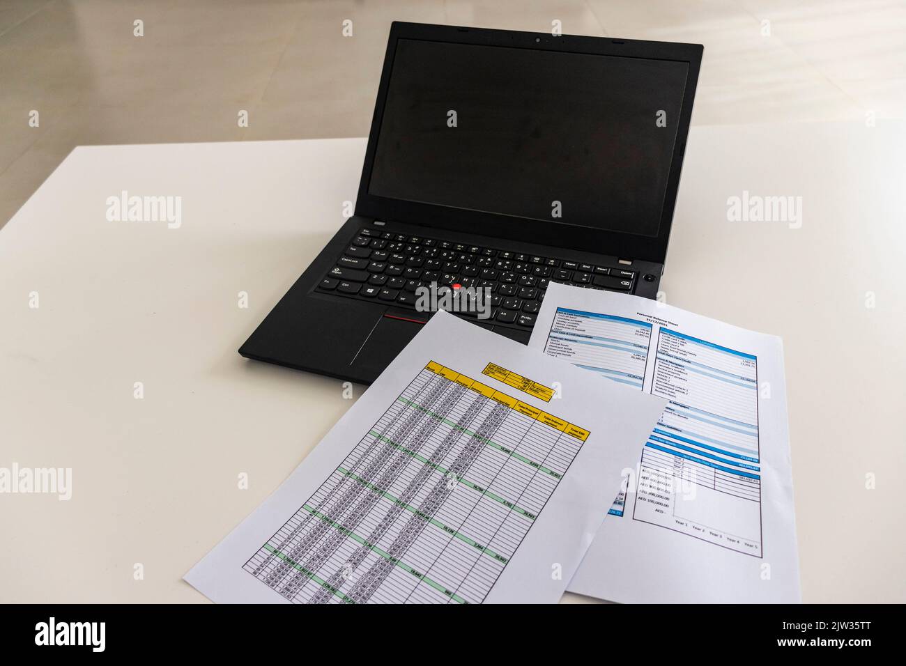 Close up shot of a print outs of excel table of a bank loan ...