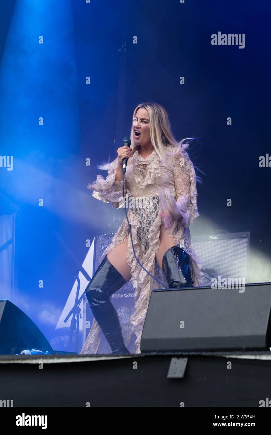 Lyra - singing to the connect audience wearing a lace thrilled blouse ...