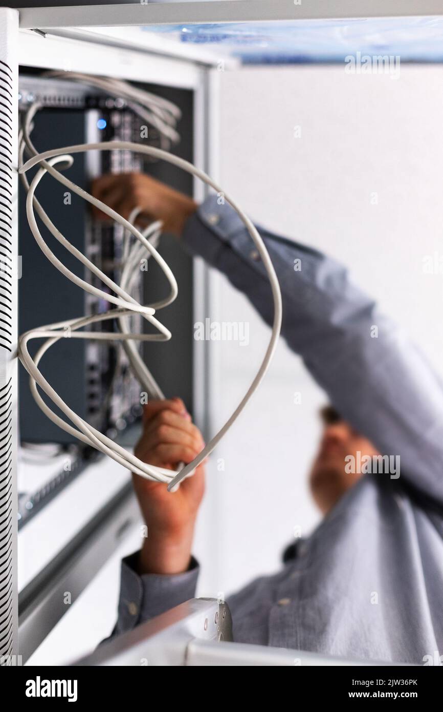 Unrecognizable man installs and connects the Internet cable to the fuse ...
