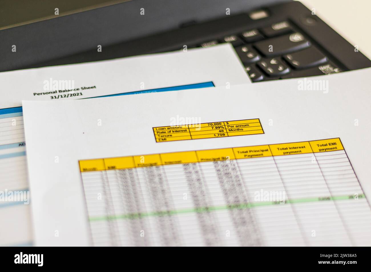 Close up shot of a print outs of excel table of a bank loan ...