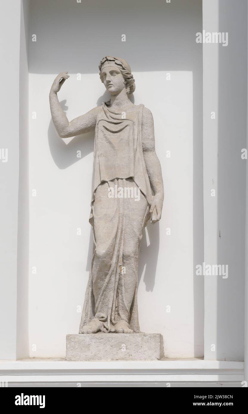 old sculpture of woman goddess in front of classic style house. Female ...