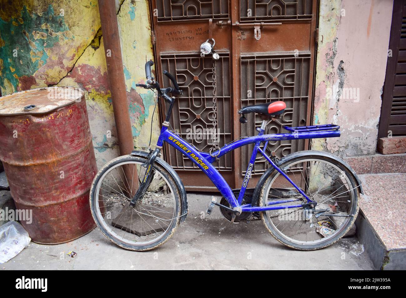 A blue Bicycle with a metallic can in India Stock Photo - Alamy