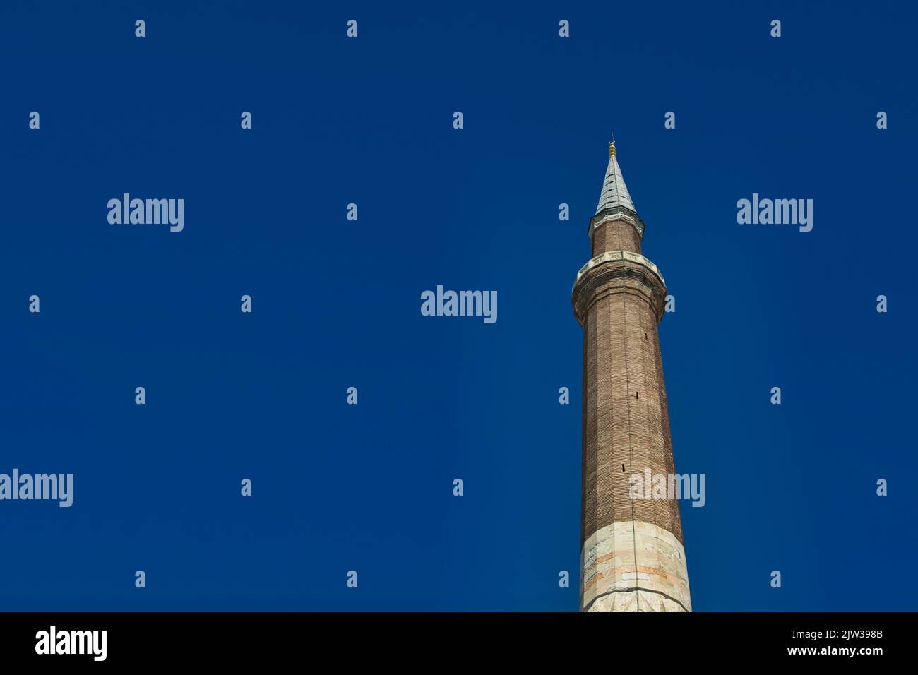 A low angle shot of a minaret against a cloudless blue sky Stock Photo ...