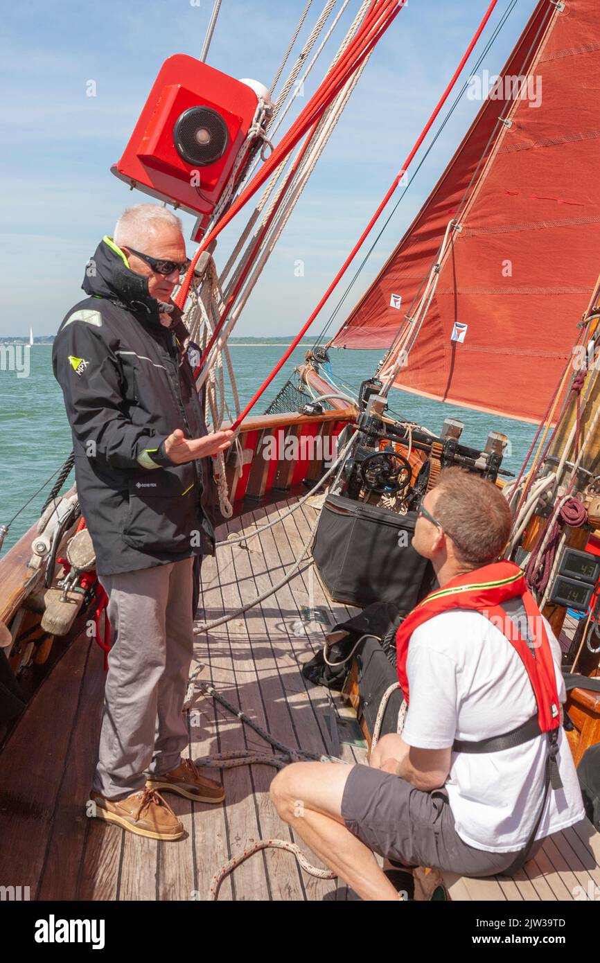 Skipper and mate discuss tactics aboard the traditional gaff cutter ...