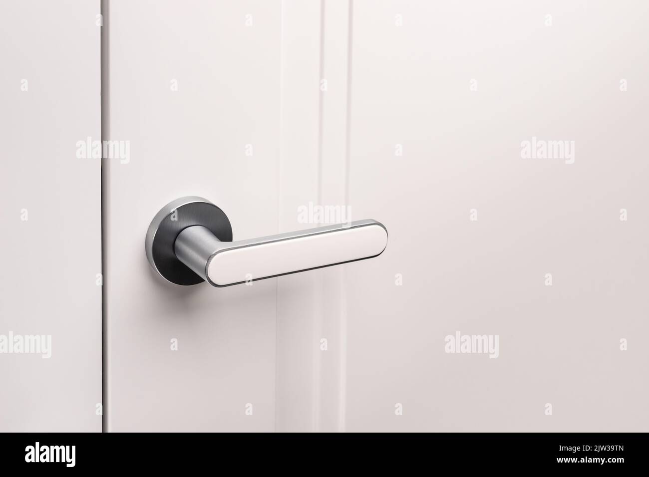 Door handles elements close up. Door handle on white closed doors in ...