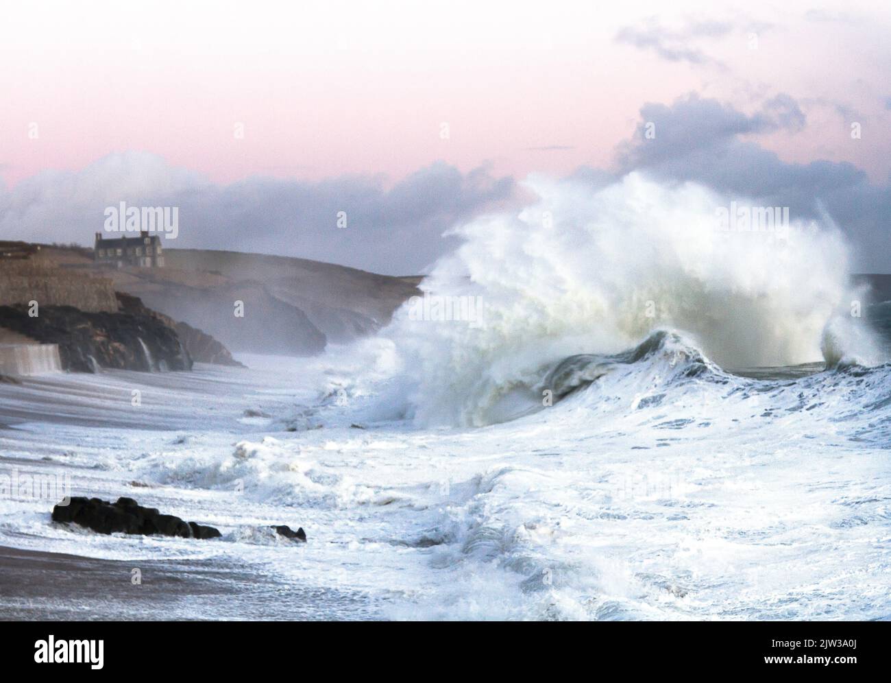 Porthleven beach awash with waves of all sizes Stock Photo - Alamy