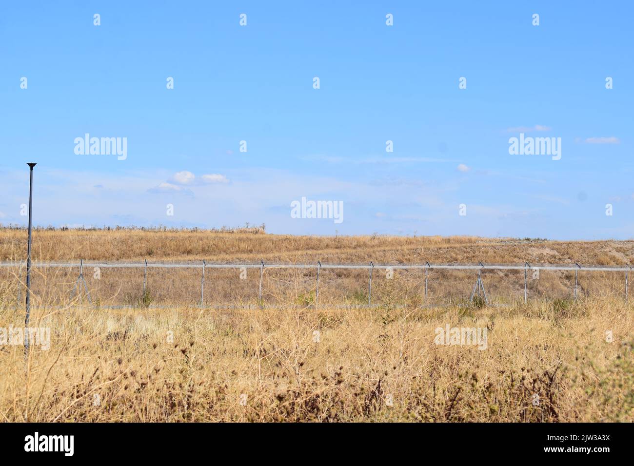 fence in dry grassland Stock Photo - Alamy