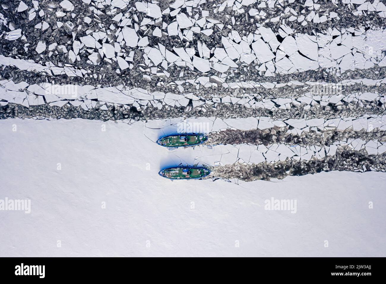 Two icebreakers on river crush the ice in Poland. Aerial view of nature ...