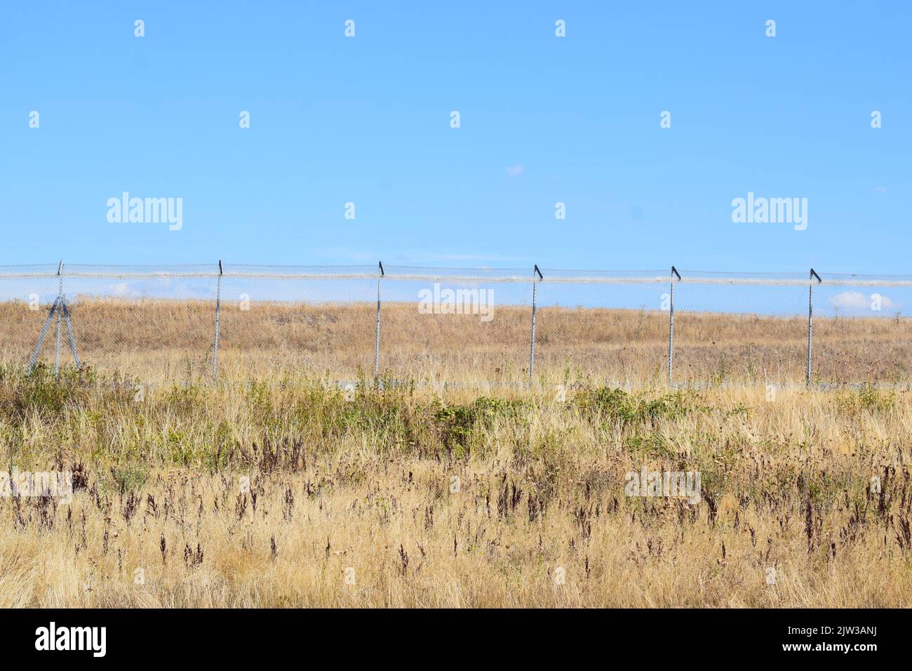 fence in dry grassland Stock Photo - Alamy