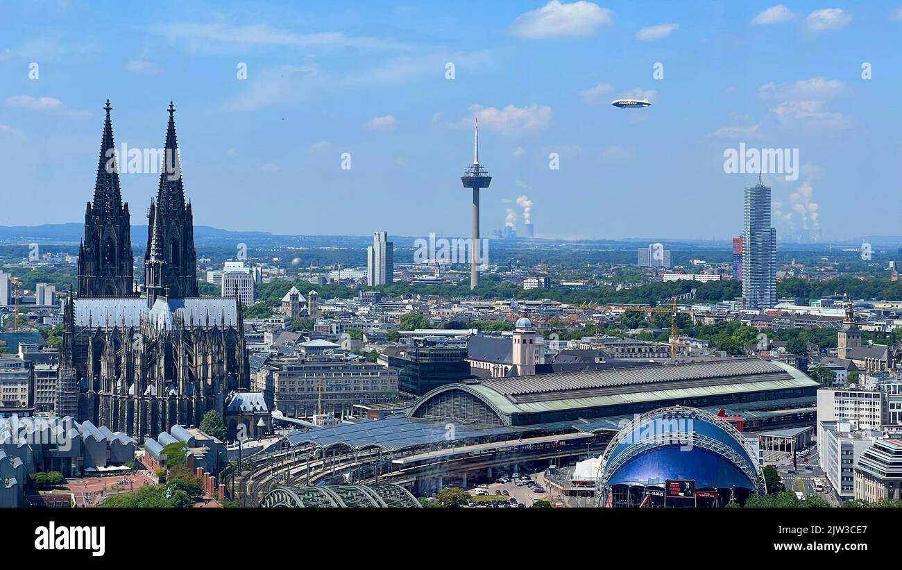 An aerial view of the famous Cologne Cathedral against a blue cloudy ...