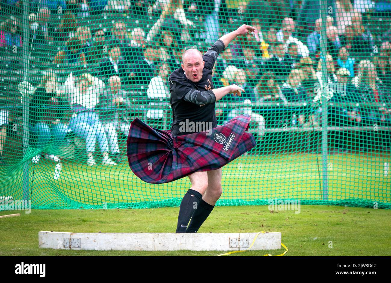 A participant competes in the weight throw during the Braemar Royal ...