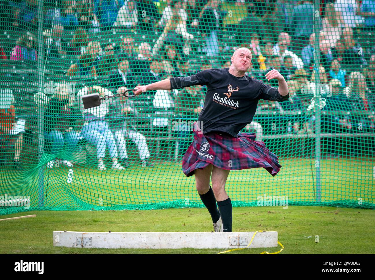 A participant competes in the weight throw during the Braemar Royal ...